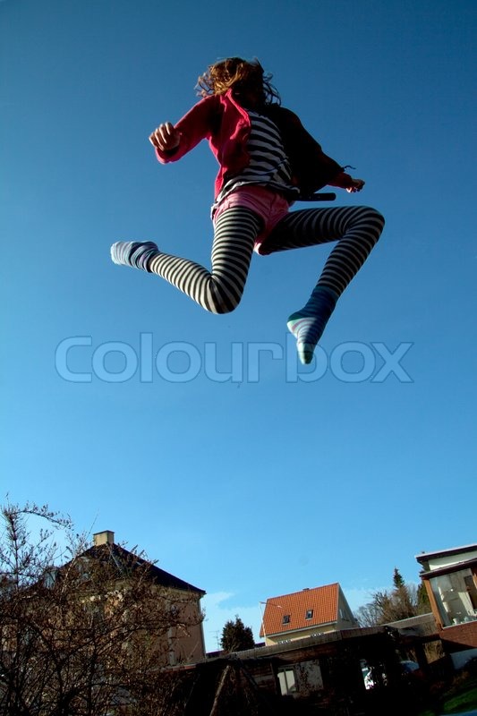 Little girl jumping high in the air ... | Stock image | Colourbox