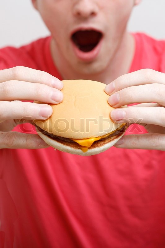 A man ready to eat a cheeseburger | Stock image | Colourbox