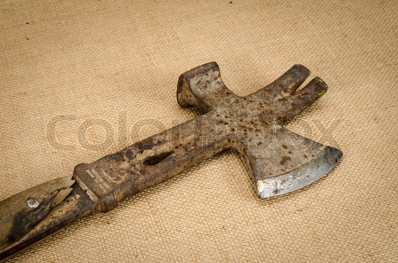 Image of ancient metal axe on brown ... | Stock image | Colourbox