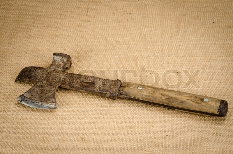 Image of ancient metal axe on brown ... | Stock image | Colourbox