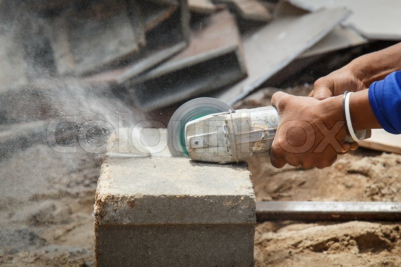 Hand holding angle grinder to cut the ... | Stock image | Colourbox