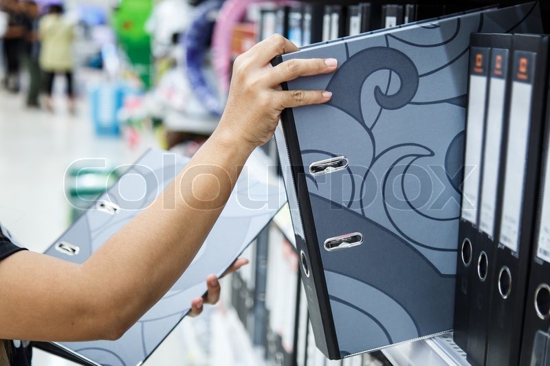 Hand of woman holding folder | Stock image | Colourbox