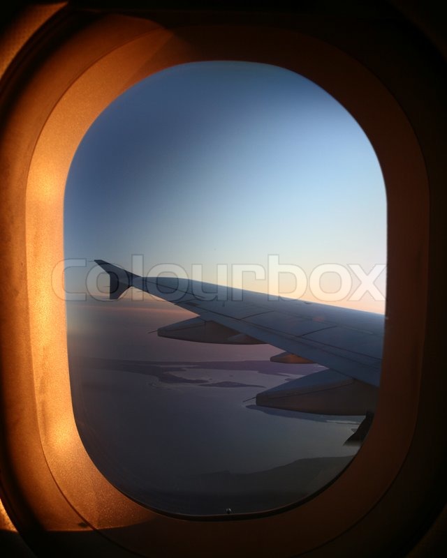 Airplane wing viewed through the window | Stock image | Colourbox
