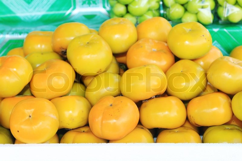 Persimmons fruit at the farmers market | Stock image | Colourbox
