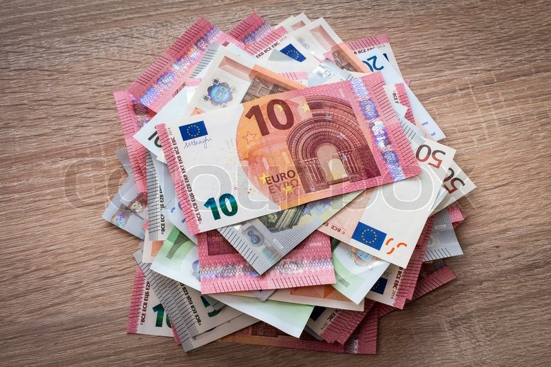 Pile of Euros on the wooden surface | Stock image | Colourbox