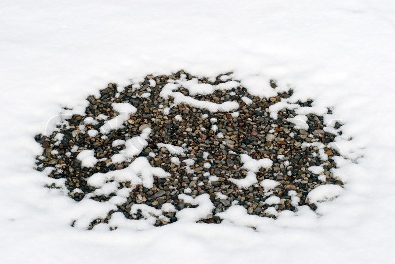 Snowy stones outdoors on gravel road at ... | Stock image | Colourbox