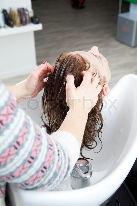 A woman getting her hair washed in a ... | Stock image | Colourbox