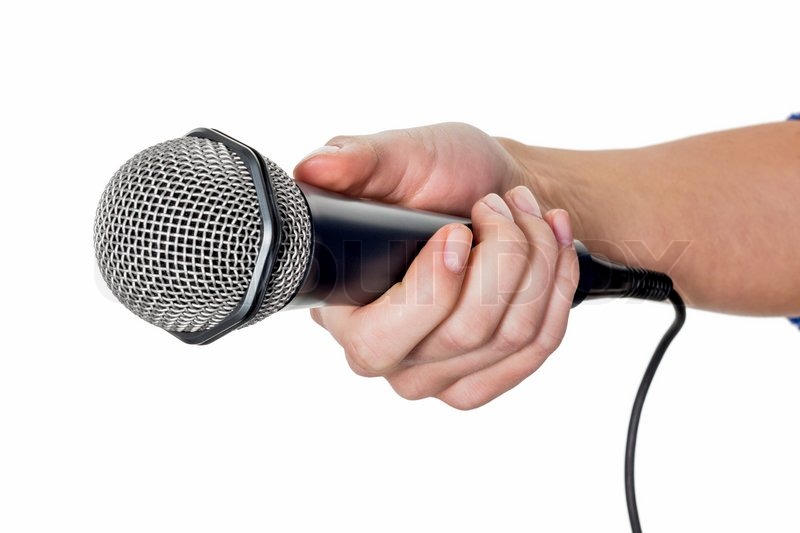 A woman is holding a microphone in his ... | Stock image | Colourbox