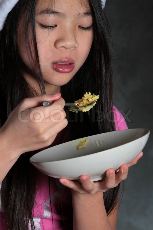 Close-up of a girl eating with spoon | Stock image | Colourbox