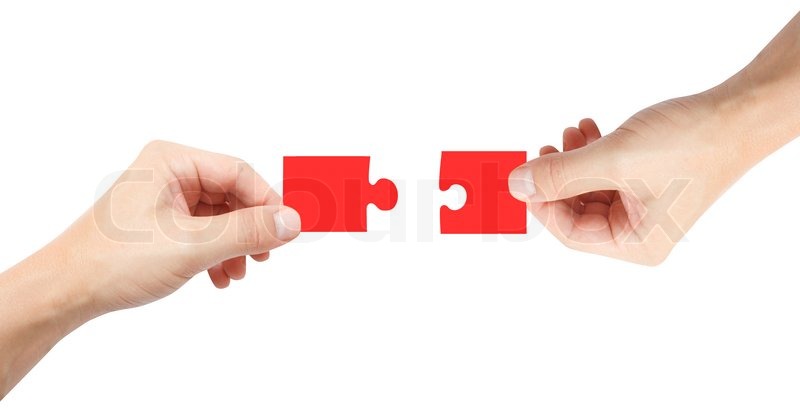Two hands holding red puzzle pieces ... | Stock image | Colourbox
