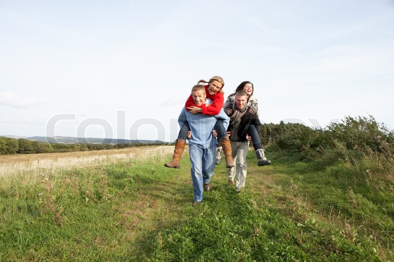 Two Couples Having Piggyback Ride In ... | Stock image | Colourbox