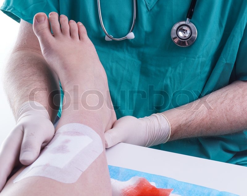 Doctor patches a Wound on the Leg | Stock image | Colourbox