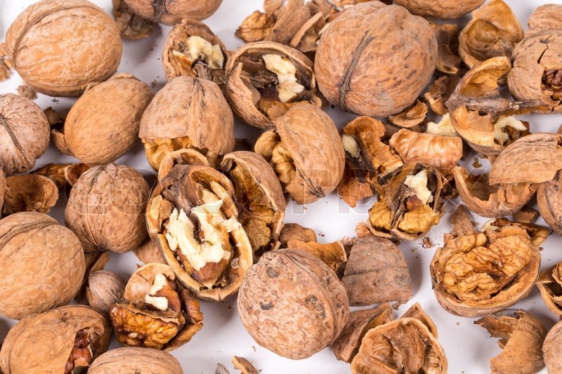 Heap of cracked walnuts. Isolated on a ... | Stock image | Colourbox