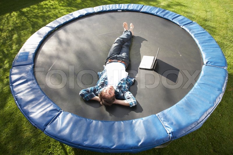 Young Man Relaxing On Trampoline With ... | Stock image | Colourbox