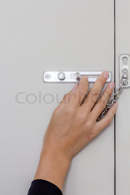 Hand opening door lock in the room | Stock image | Colourbox