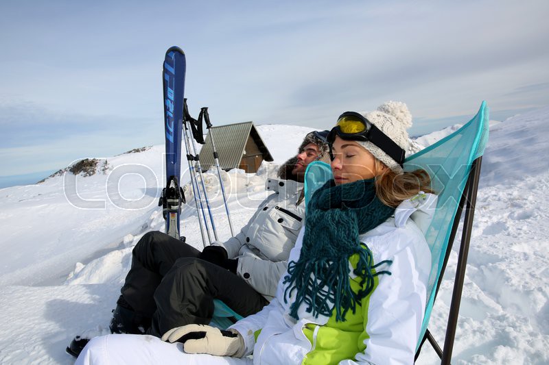 Couple of skiers relaxing in long ... | Stock image | Colourbox