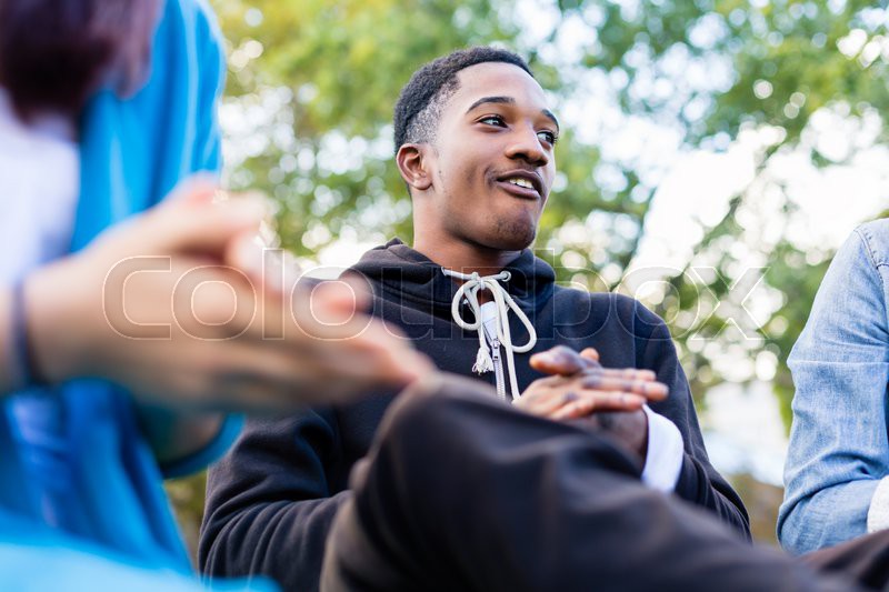 Friends clapping along to music in park ... | Stock image | Colourbox