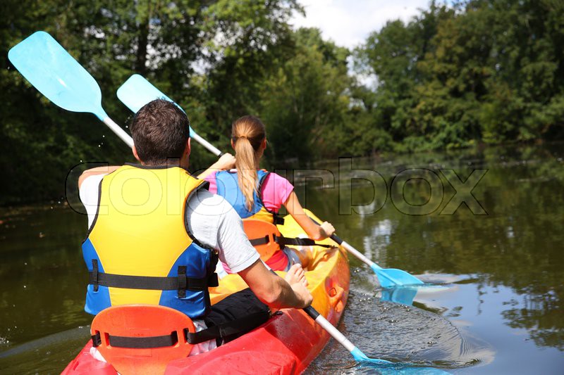 Couple riding canoe in river | Stock image | Colourbox