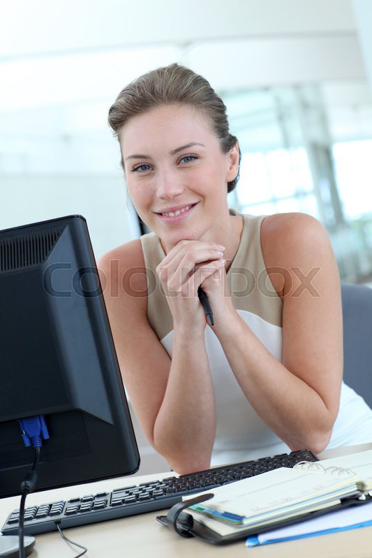 Beautiful blond office-worker sitting ... | Stock image | Colourbox