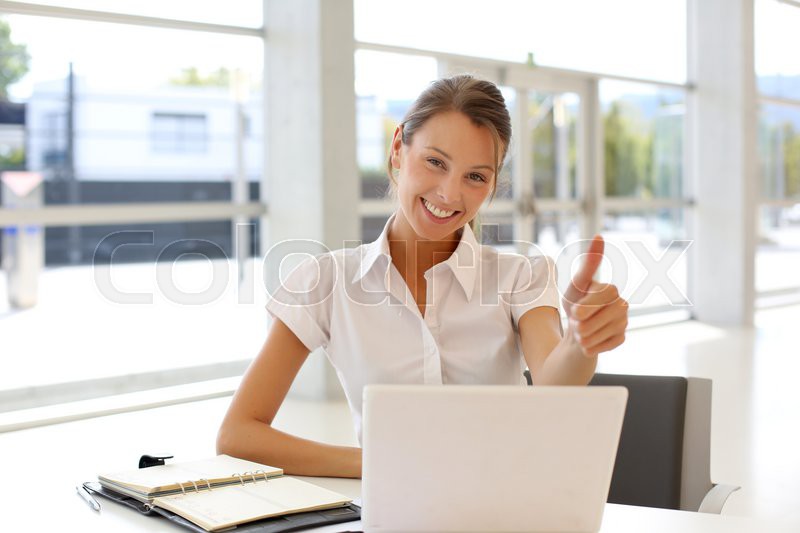 Cheerful office-worker showing thumbs ... | Stock image | Colourbox
