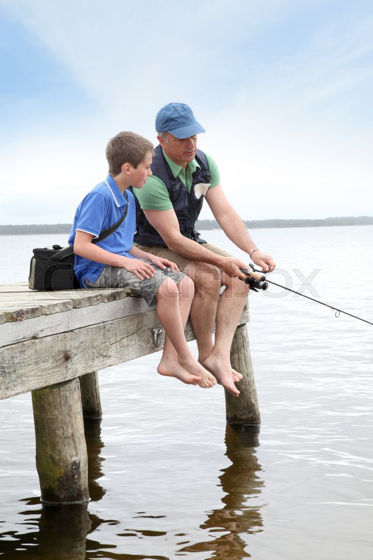 Father and son fishing in lake | Stock image | Colourbox