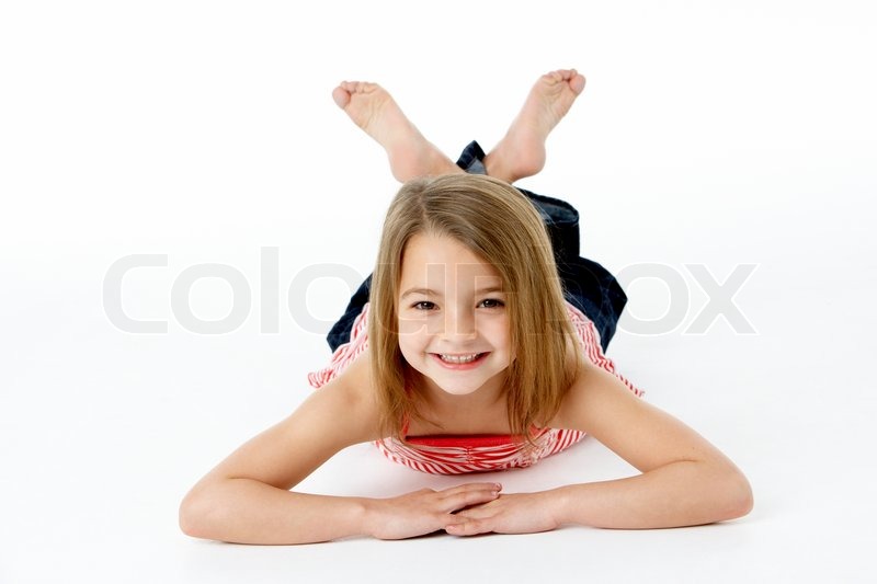 Young Girl Lying On Stomach In Studio | Stock Photo | Colourbox