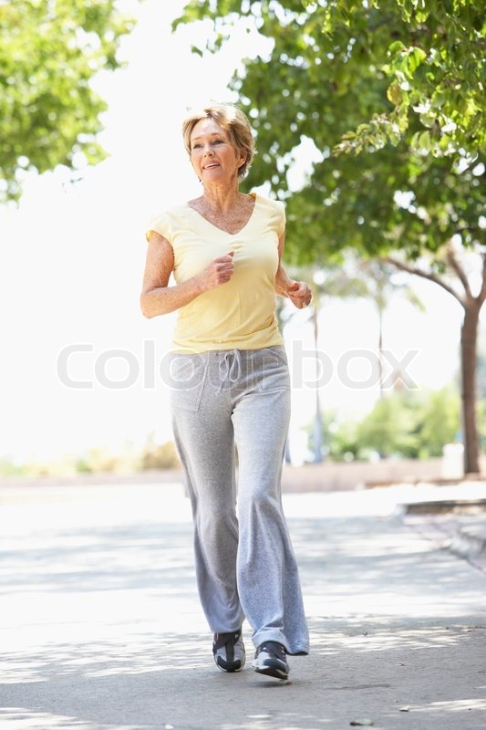 Senior Woman Jogging In Park | Stock Photo | Colourbox