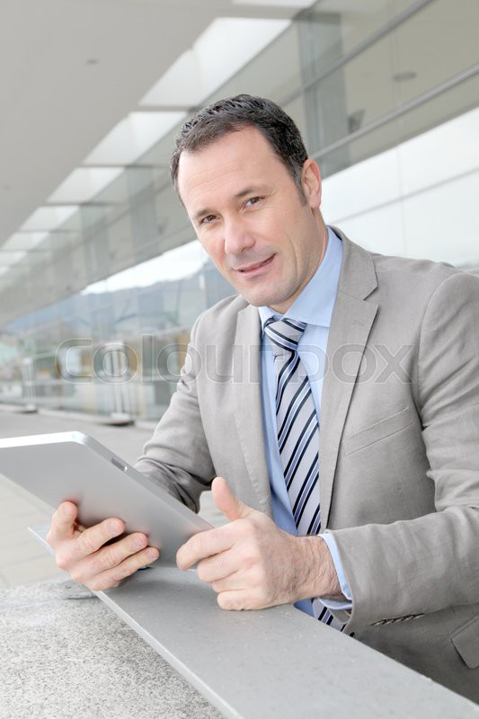 Businessman using electronic tab ... | Stock image | Colourbox