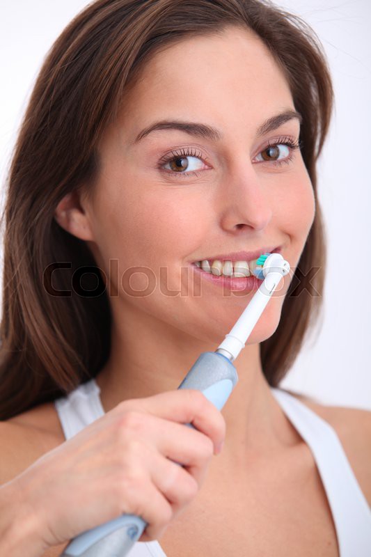 Closeup of beautiful woman brushing her ... | Stock image | Colourbox