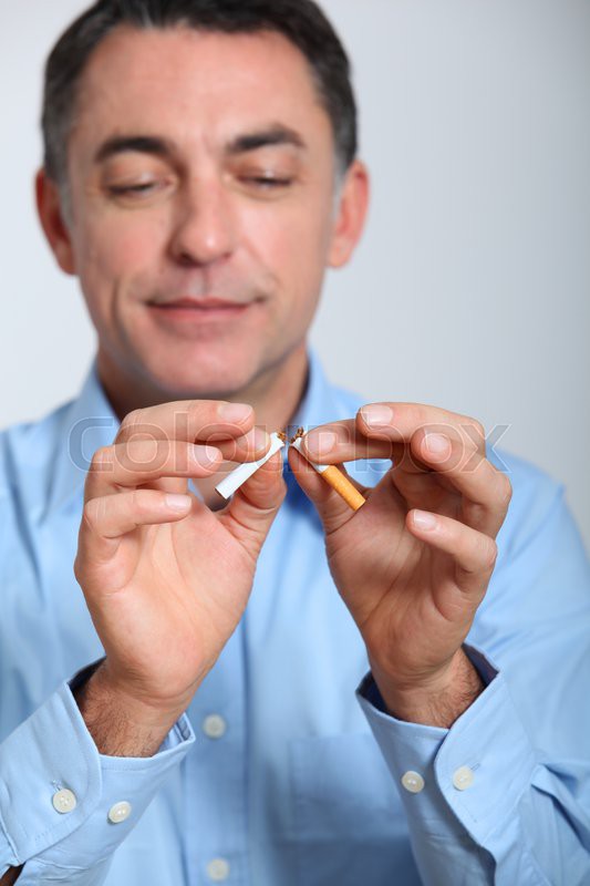 Closeup of man trying to quit smoking | Stock image | Colourbox
