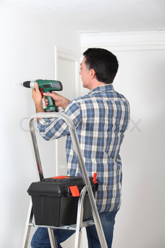 Man using electric drill at home | Stock image | Colourbox