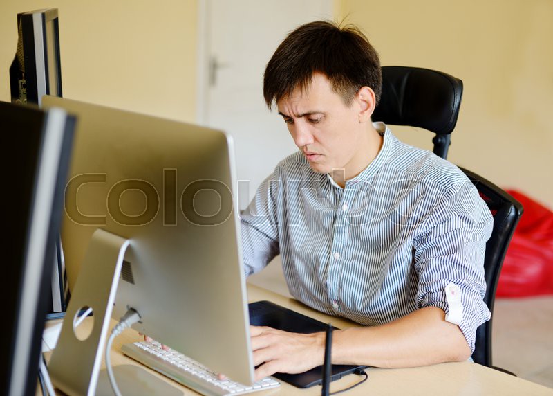 Young man is working in the office | Stock Photo | Colourbox