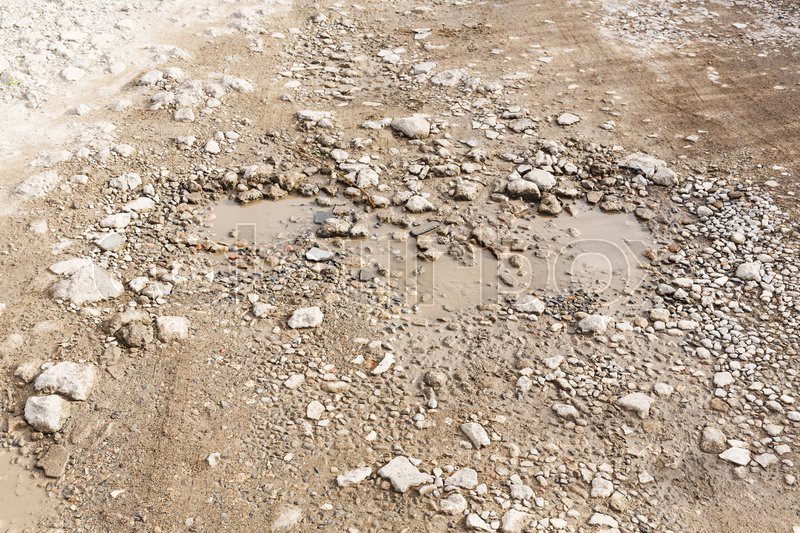 Close up bumpy stone road with water in ... | Stock image | Colourbox