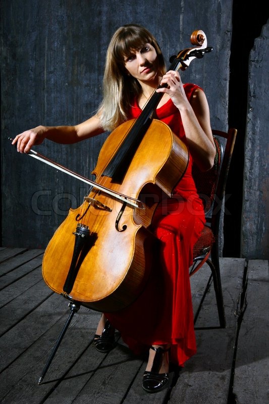 Beautiful cello musician on grey wall ... | Stock image | Colourbox