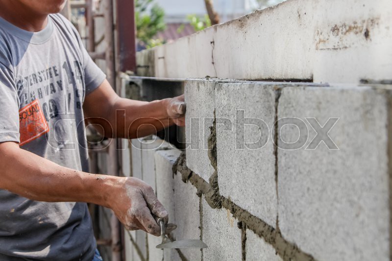 Construction mason worker install ... | Stock image | Colourbox