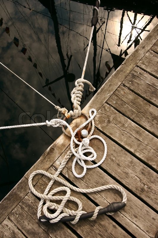 Rope on the dock of a little harbour | Stock Photo | Colourbox