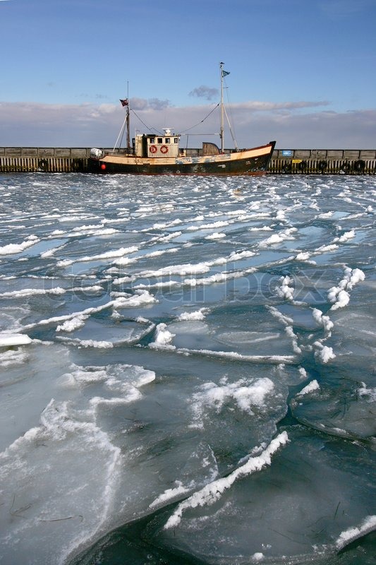 Fishing boat in the ice in a small ... | Stock image | Colourbox