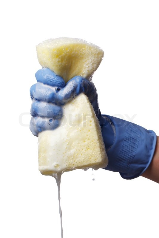 Hand holding a yellow sponge dripping ... | Stock image | Colourbox