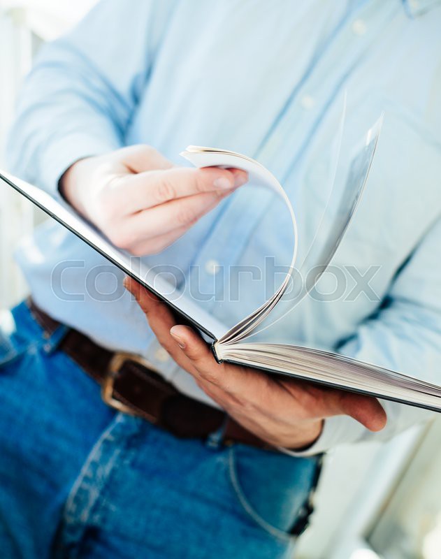 Closeup on a man reading a magazine. ... | Stock image | Colourbox