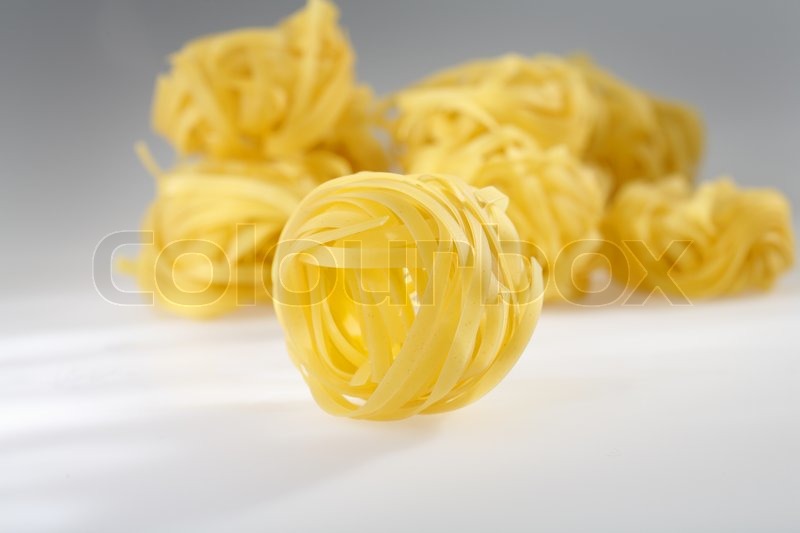 Uncooked italian pasta tagliatelle ... | Stock Photo | Colourbox