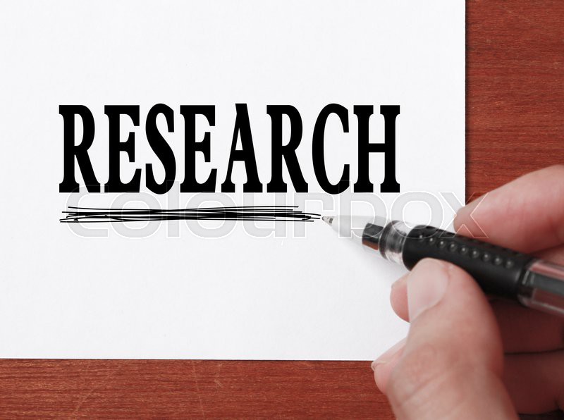 Businessman is writing Research text on ... | Stock image | Colourbox