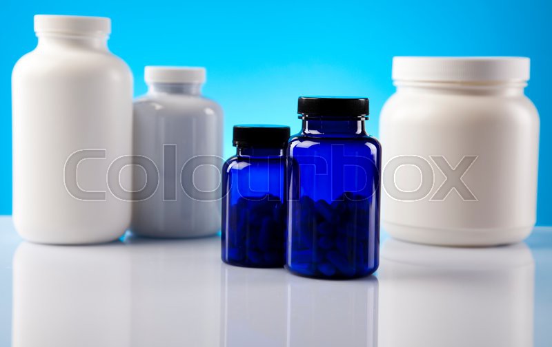 Fitness supplement and blue background | Stock image | Colourbox