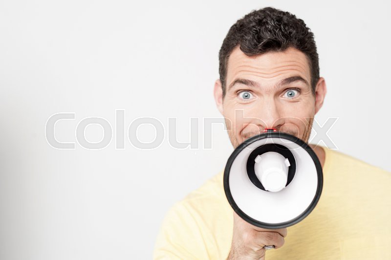 Excited man making advertisement in ... | Stock image | Colourbox