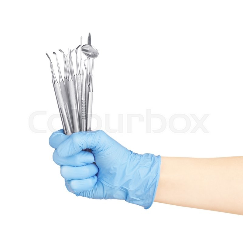 Hands holding dental instruments | Stock image | Colourbox