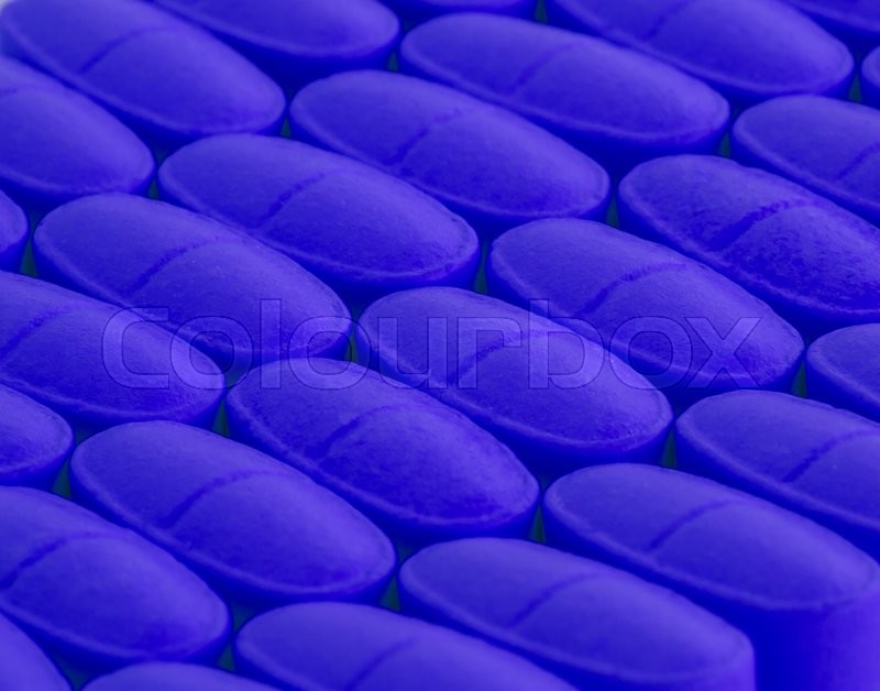Bunch of blue pills spilled on the ... | Stock image | Colourbox
