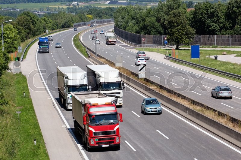 Trucks on a three-lane highway. ... | Stock image | Colourbox