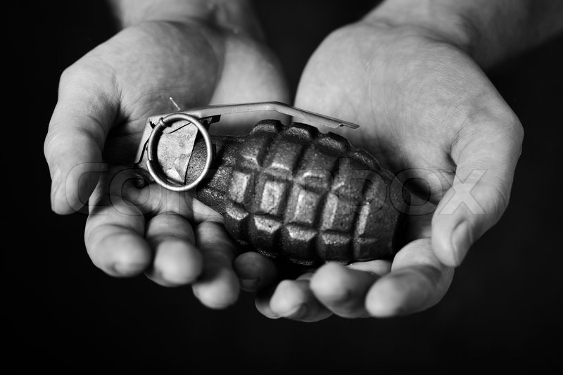 Man holding an old hand grenade in his ... | Stock image | Colourbox