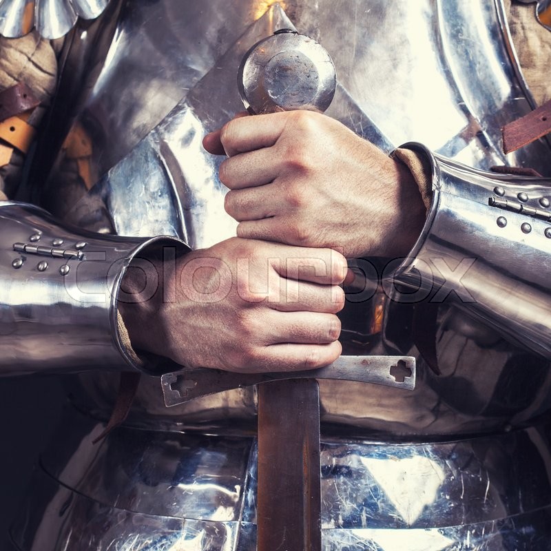 Knight wearing armor and holding ... | Stock image | Colourbox