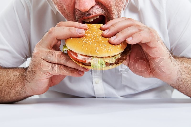 Close-up portrait of man eating burger | Stock image | Colourbox