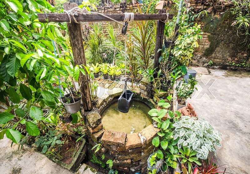 Ancient brick well in the garden | Stock Photo | Colourbox
